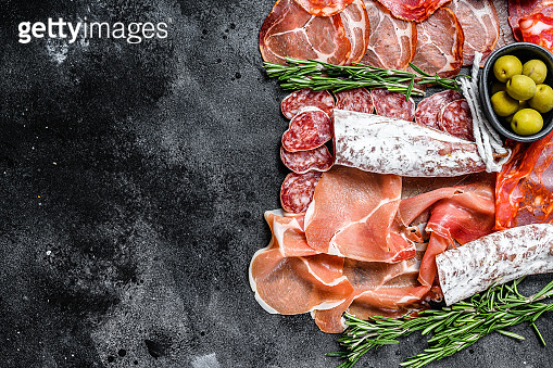 Cured meat platter of traditional Spanish tapas. Chorizo, jamon serrano ...
