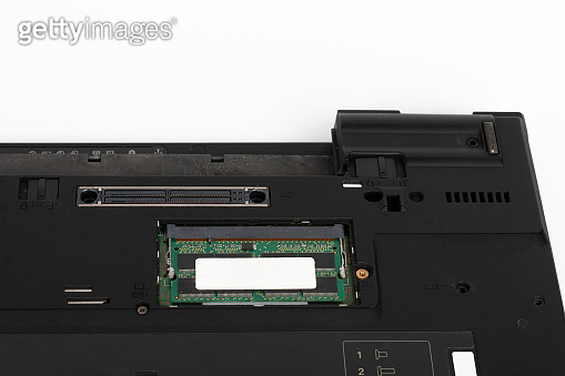 Close up of laptop memory module on slot of motherboard. Underside of ...