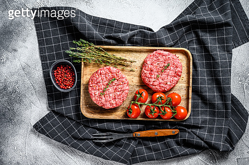 Raw burgers cutlets, organic ground beef meat. Gray background. Top ...