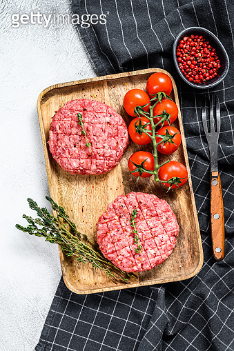Raw burgers cutlets, organic ground beef meat. Gray background. Top ...
