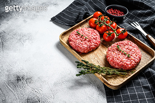 Raw burgers cutlets, organic ground beef meat. Gray background. Top ...