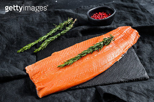 Raw trout fillet with rosemary and pink pepper. Organic fish. Black ...
