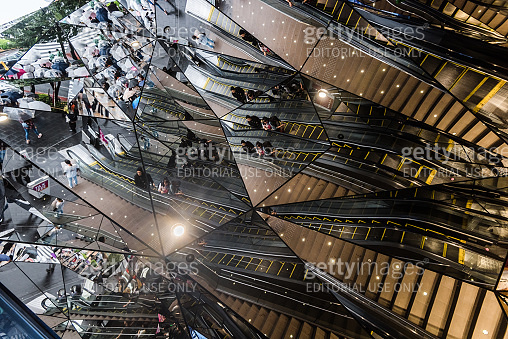 People are seen reflected in a mirror as they walk through The famous ...