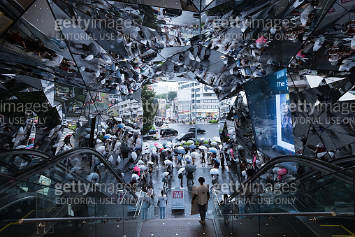 People are seen reflected in a mirror as they walk through The famous ...