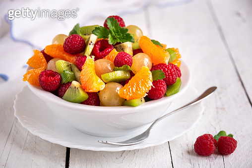 Fresh fruit salad with with raspberry, mandarin and other fruit ...