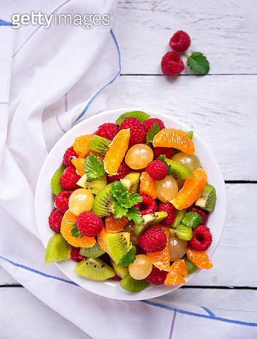 Fresh fruit salad with with raspberry, mandarin and other fruit ...