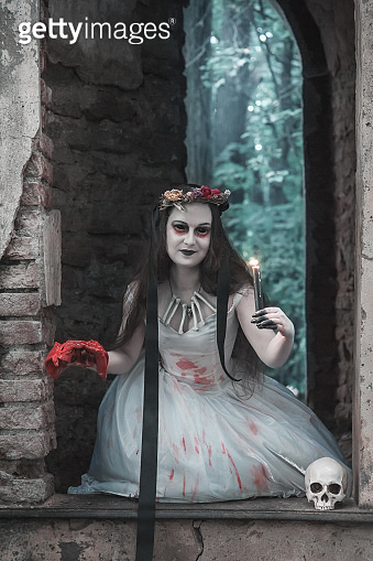 Creepy dead bride with bloody meat and candle. Halloween scene ...