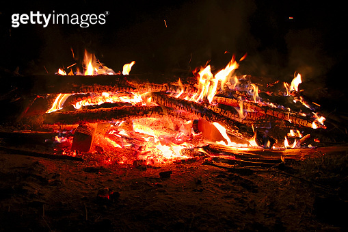 Night fire. A bright fire of wood and darkness. Brightly burning ...
