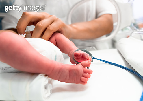 Nurse takes action to monitor and care for premature baby, selective ...