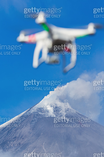 Flying UAV drone quadcopter aerial photography in sky on background ...
