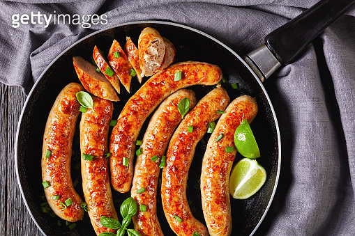 Breakfast pork sausage links or patties fried on a skillet with fresh ...