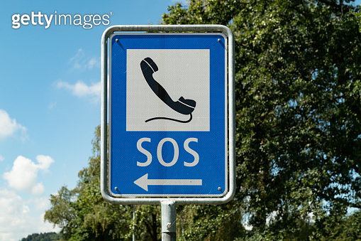 emergency phone sign painted with black phone on white-blue background ...