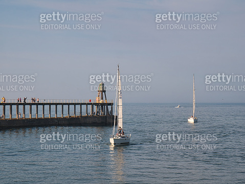 Sail boats arriving at Whitby Harbour in North Yorkshire, England, UK ...