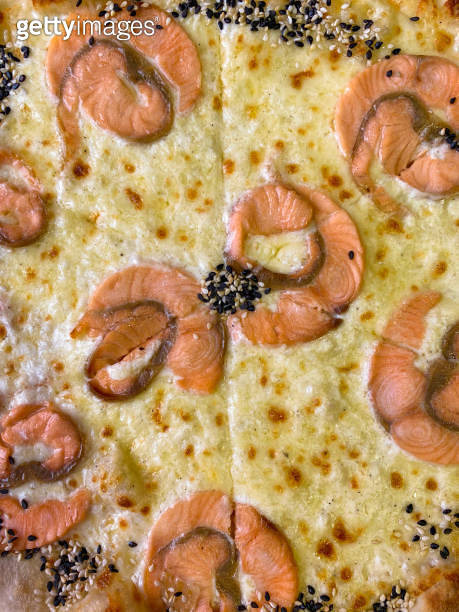 Top view on hot seafood pizza. Fried yeasted flatbread topped with red ...