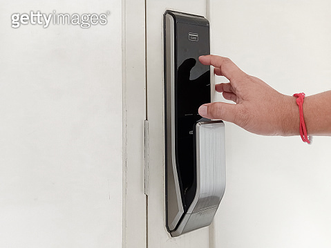 Home security system. hand pressing password code to lock and unlock ...