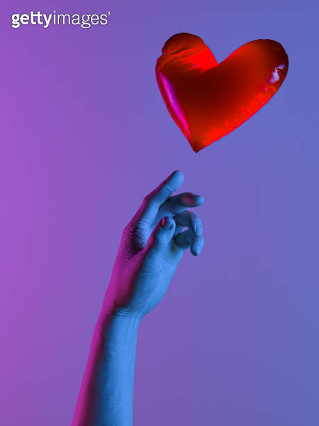 Human Hand Lightened With Blue And Pink Neon Lights Sending Red Heart ...