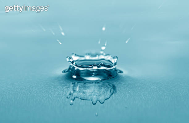 Close-up macro picture of drop on water surface, water drops splash as ...