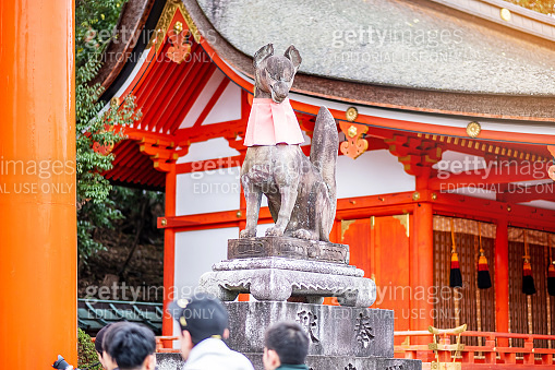Fox sculpture in Fushimi Inari-taisha shrine in fall autumn season ...