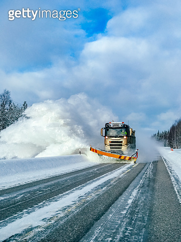Winter service truck for snow plow clearing road after winter snowstorm ...