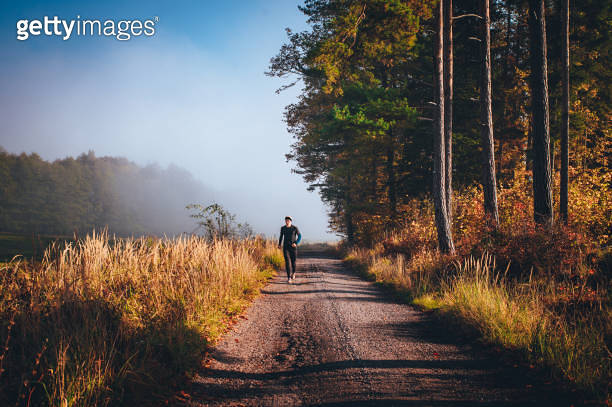Runner in beautiful amazing Autumn nature. Sport in beautiful landscape ...