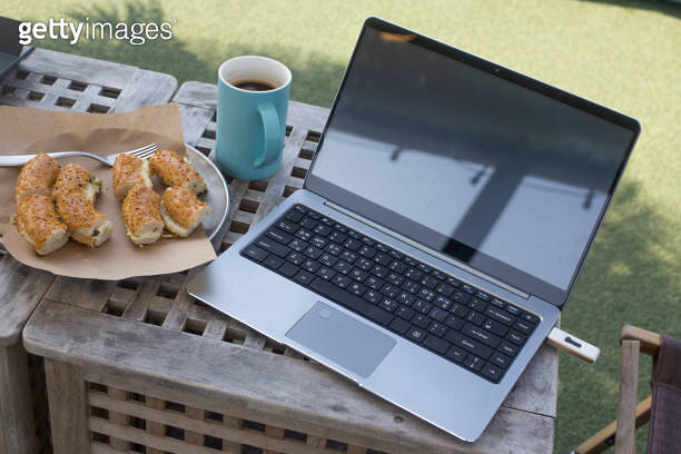 open laptop computer, bread and coffee with outdoor background. 이미지 ...