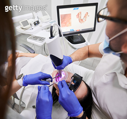 Doctor scanning patient mouth with modern intraoral scanner ...