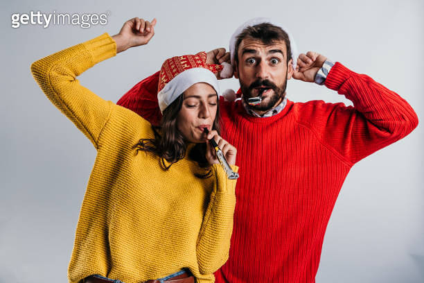 Loving foolish couple making funny faces and celebrating New Year and ...