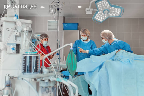 A team of doctors performs an operation. A group of surgeons at work in ...