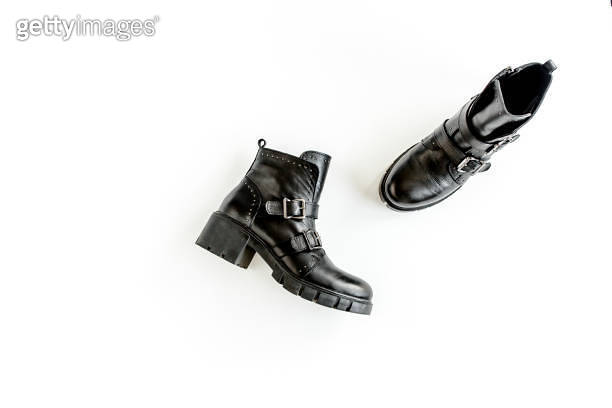 Black female boots on white background. Flat lay, top view minimal ...