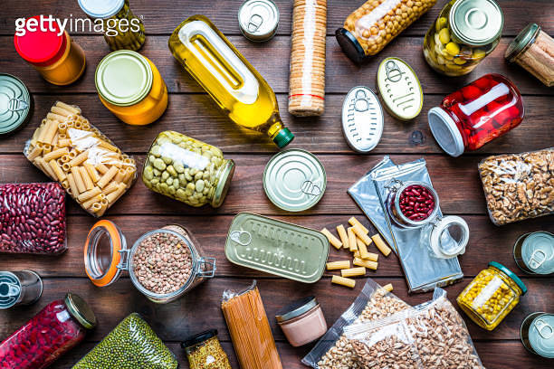 Non-perishable food background: canned goods, conserves, sauces and ...