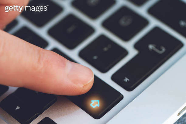 Closeup of Man's Finger Touching the Letter Shift Key button on Black ...