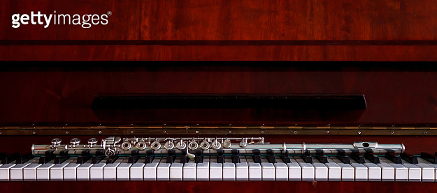Flute with piano. Flute on piano keys. Wind instrument for musical ...