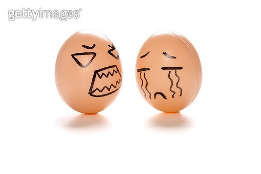 egg faces of an angry one blaming a crying one on white with clipping ...