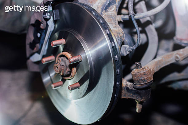 installation of a ventilated brake disc of a car on a hub in a garage ...