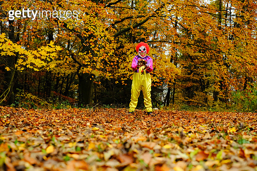 Halloween.Halloween masquerade party.A scary clown with red hair and a ...