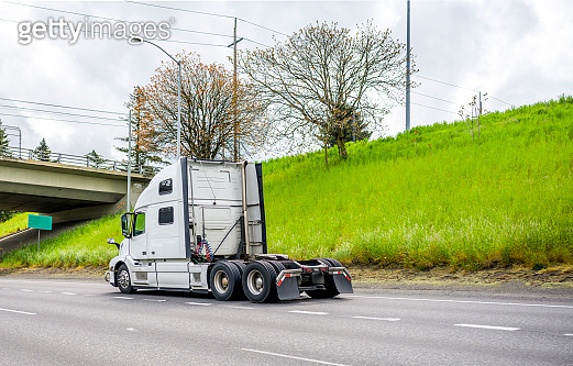Big rig diesel semi truck tractor running on the highway road to ...