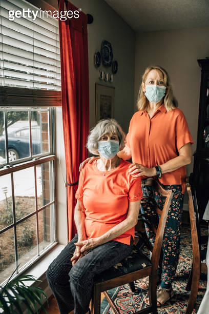 A baby boomer daughter taking care of her elderly shut-in mother in her ...