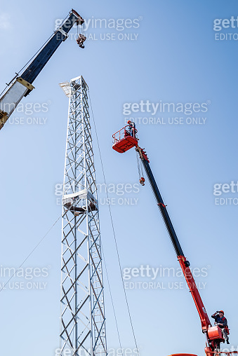 Installation of a truss tower of a wind turbine using a crane and ...