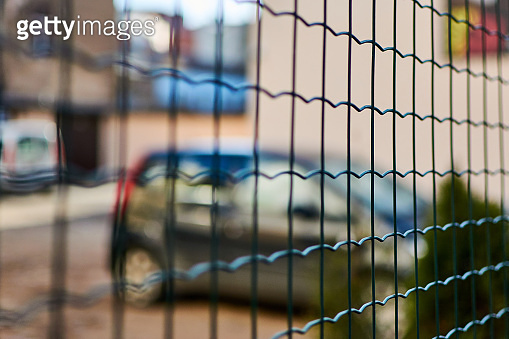 Car behind the fence net. Parking, fine area. 이미지 (1226027707) - 게티이미지뱅크