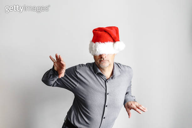 Happy man with a red Santa hat over his eyes (1282980165) - 게티이미지뱅크