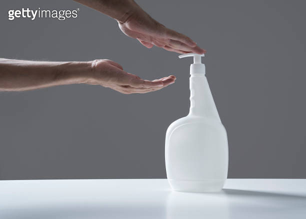 Human hands using alcohol hand sanitizer to prevent from virus ...