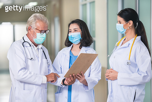 Three doctor talking in hospital corridor. health care (1283605349 ...
