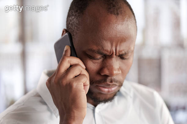 Portrait of a man looking intently into the distance and talking on the ...