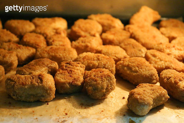 Image of inside of oven showing chicken nuggets cooking in baking tray ...