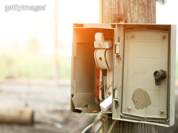 Old cut-out or circuit breaker on the Wooden pole. Old electrical ...