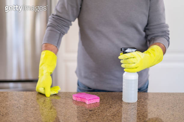 Man Sanitizing the Counter with Disinfectant and Sponge (1213539174 ...
