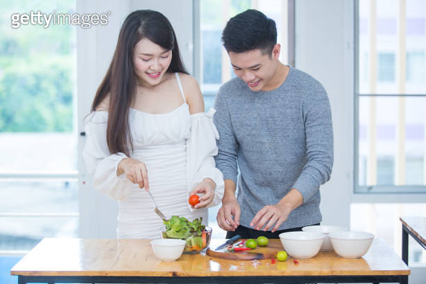 Asian couples making salads and eating cleanfood , healthy meals. Stay ...