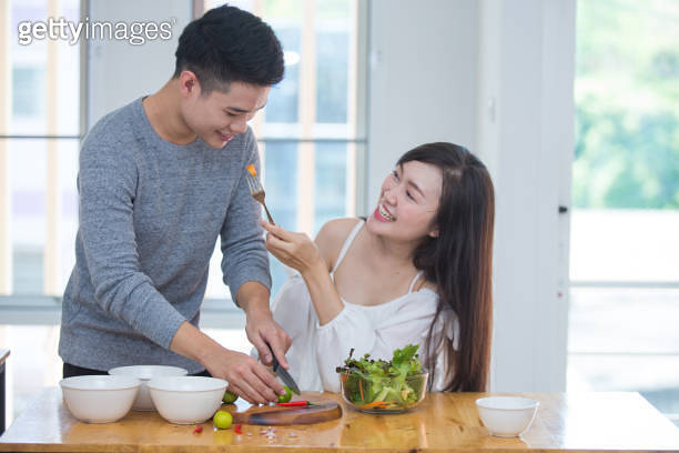 Asian couples making salads and eating cleanfood , healthy meals. Stay ...