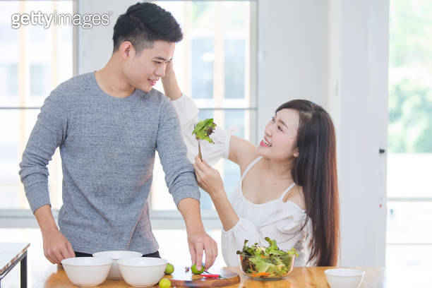Asian couples making salads and eating cleanfood , healthy meals. Stay ...