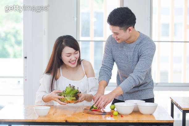 Asian couples making salads and eating cleanfood , healthy meals. Stay ...